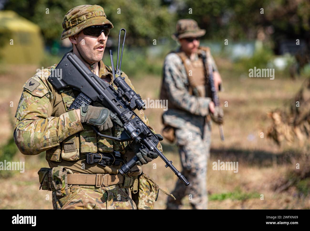 An Australian Solider and a U.S. Marine, conducts Individual Movement ...
