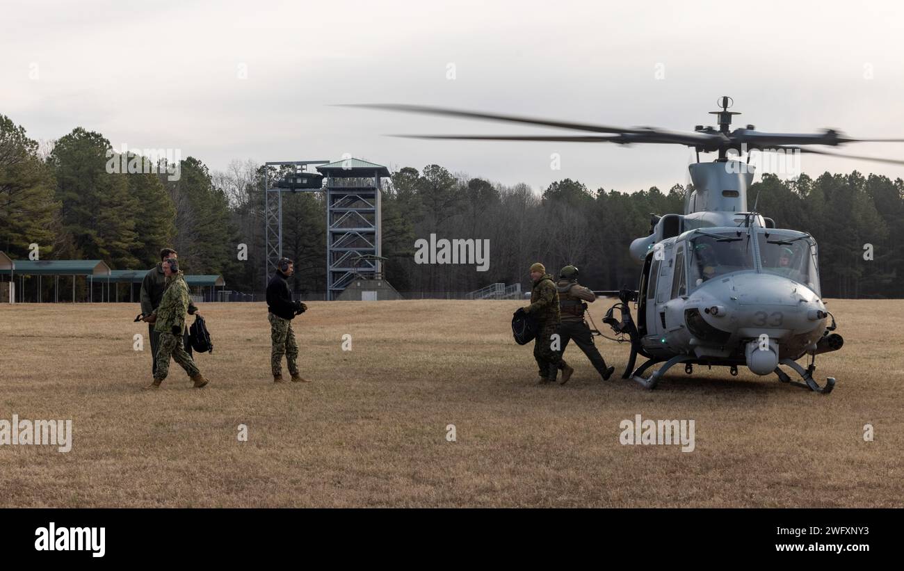 U.S. Sailors with Amphibious Squadron 4 exit a UH-1Y Venom with Marine ...