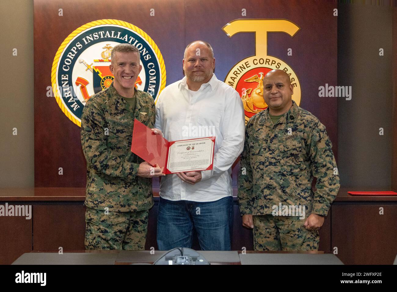 Clint Westrich, center, recipient of the Employee of the Quarter award ...