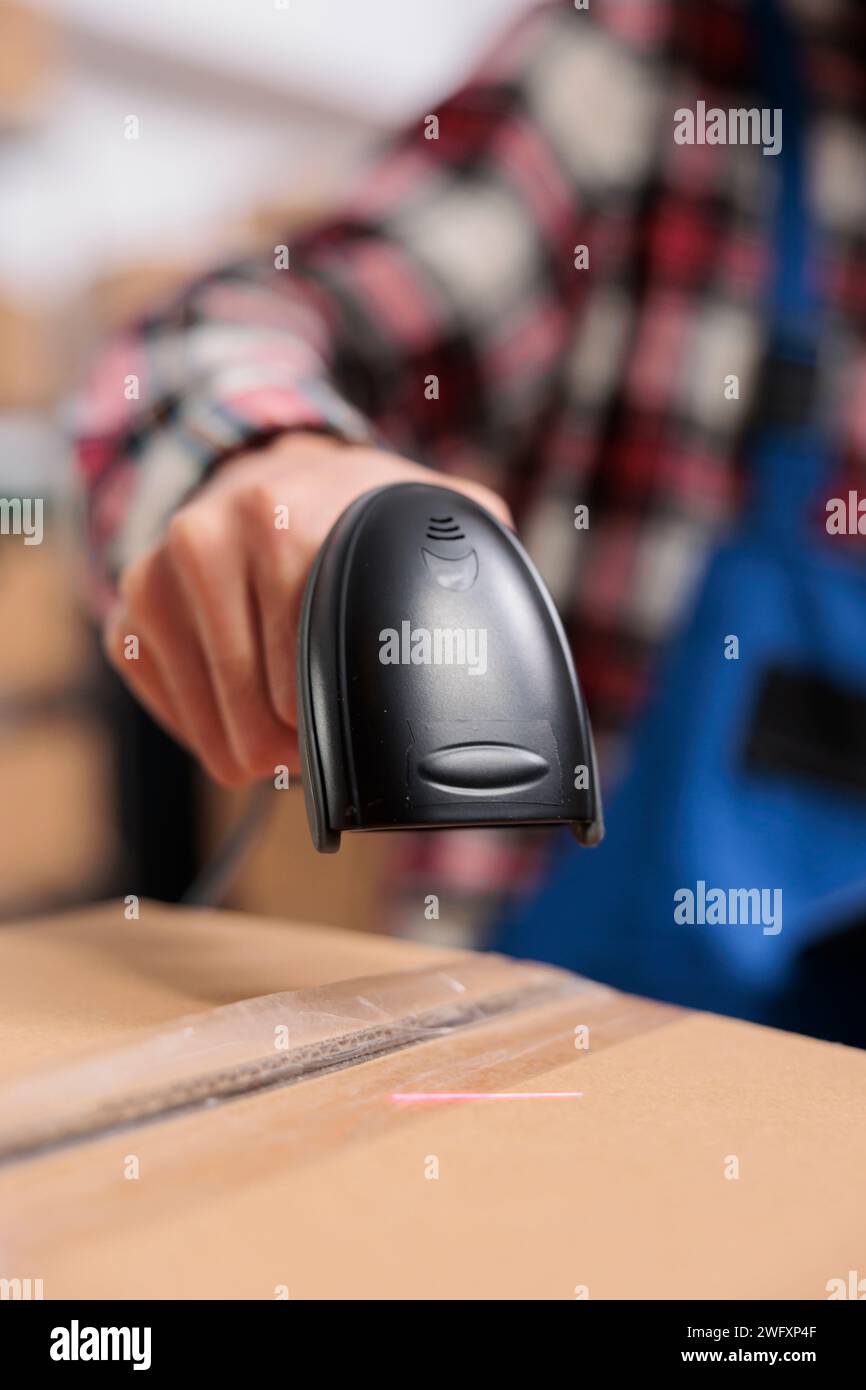 Delivery service employee scanning parcel and managing packages storing ...