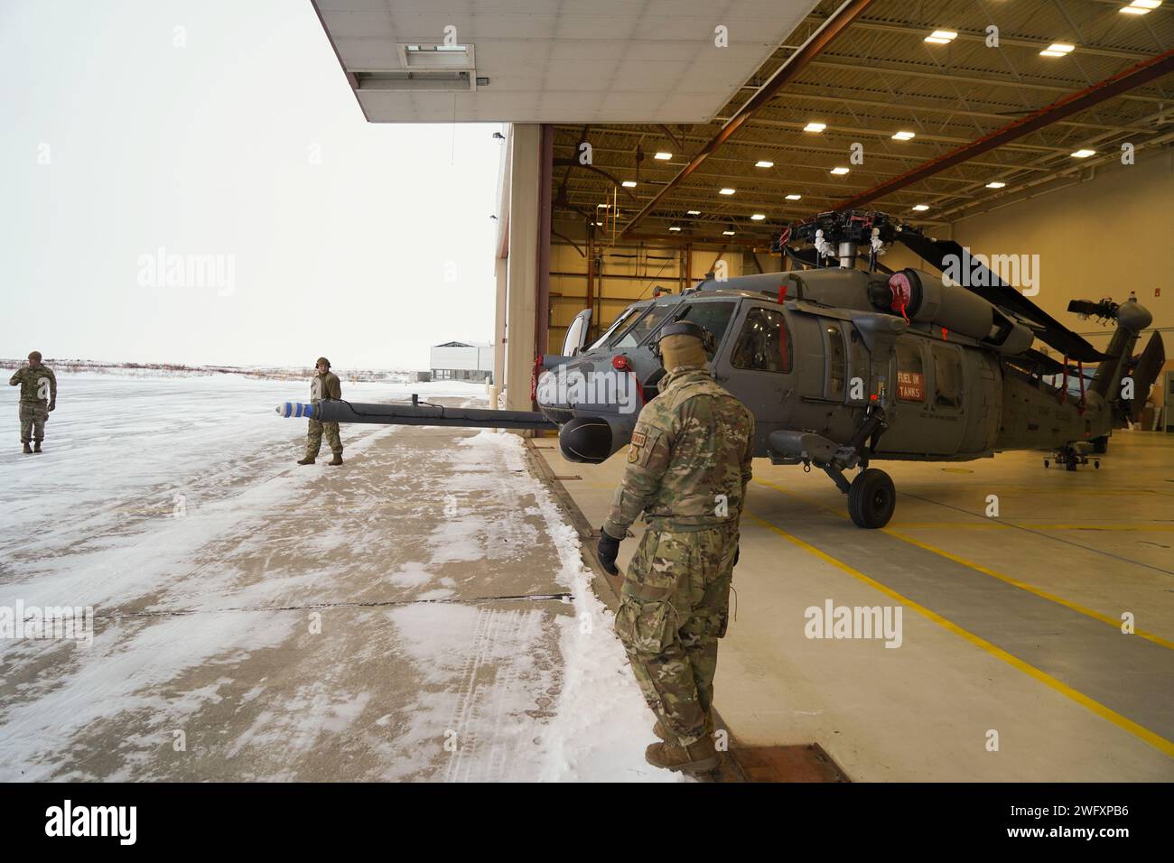 Airmen from the 176th and 718th Aircraft Maintenance Squadrons tow an ...