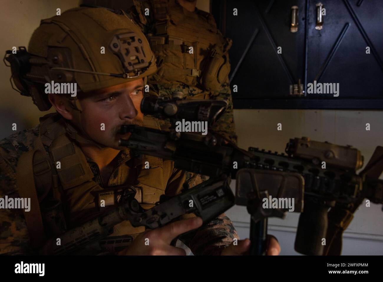 U.S. Marine Corps Cpl. Caleb Eden, a scout sniper with Battalion Landing Team 1/1, fires on a ...
