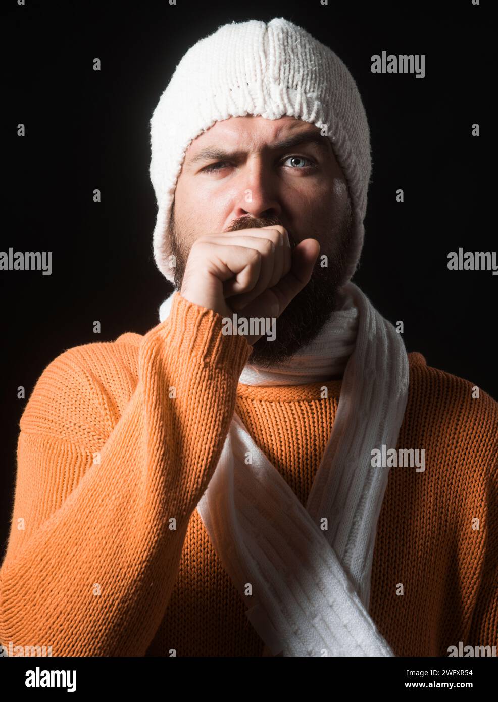 Sick bearded man with sore throat coughing into his fist. Ill man have ...