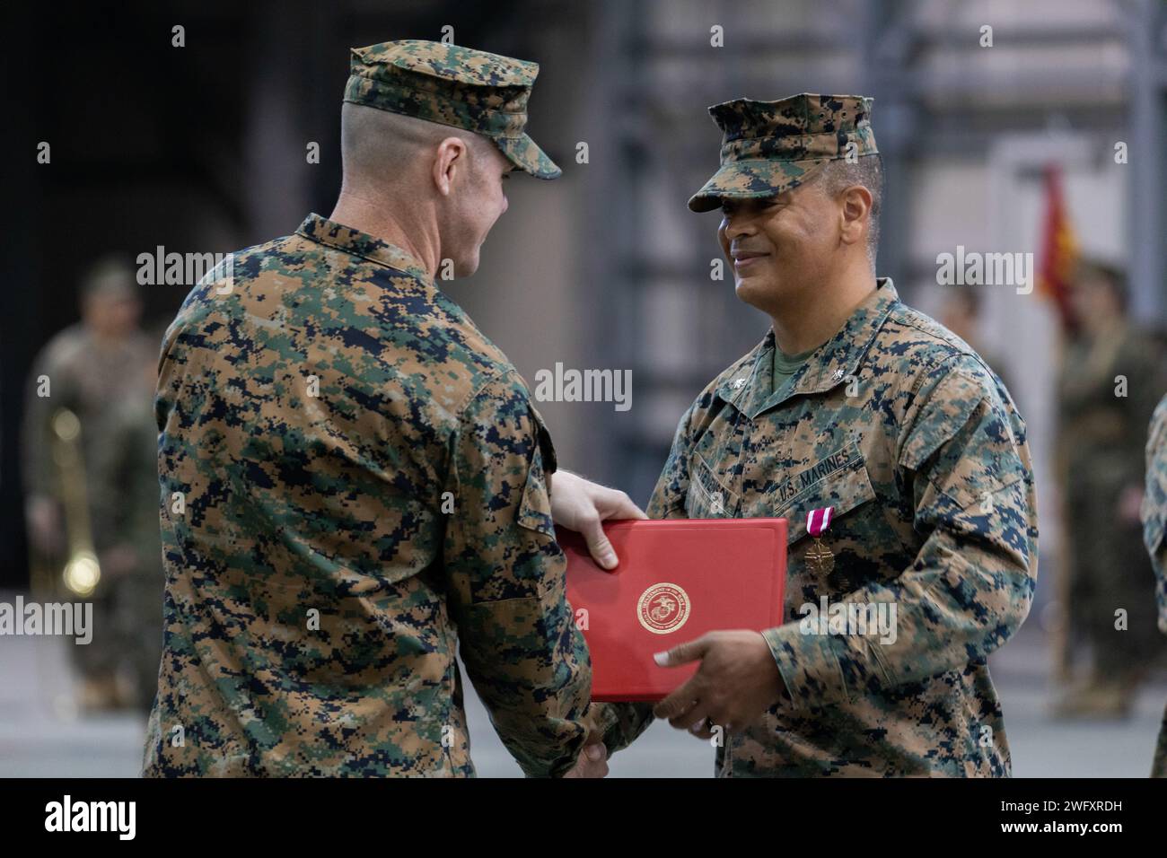 U.S. Marine Corps Lt. Col. Robert Stevenson III, right, shakes hands ...
