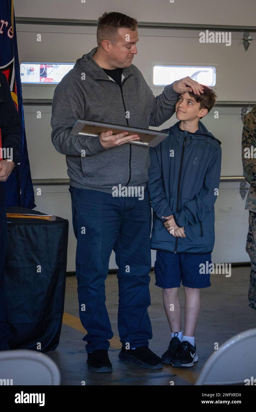 Christopher Henson and his son, Declan, present an engraved plaque to the firefighters of Camp ...