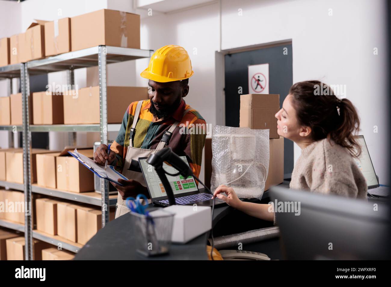 African american coworker analyzing goods checklist with stockroom ...