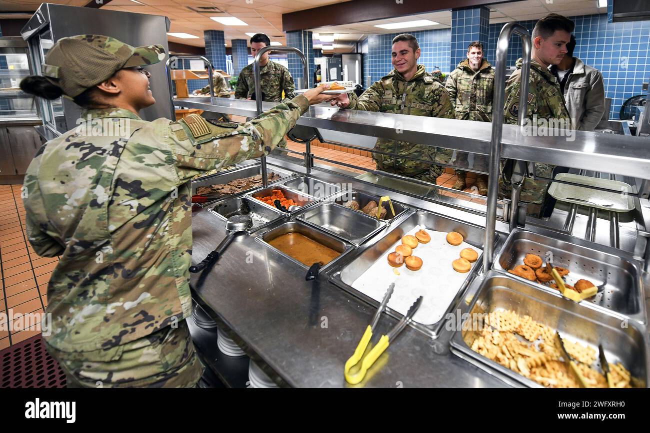 Airman 1st Class Kierra Worley hands a plate of food to an airman at ...