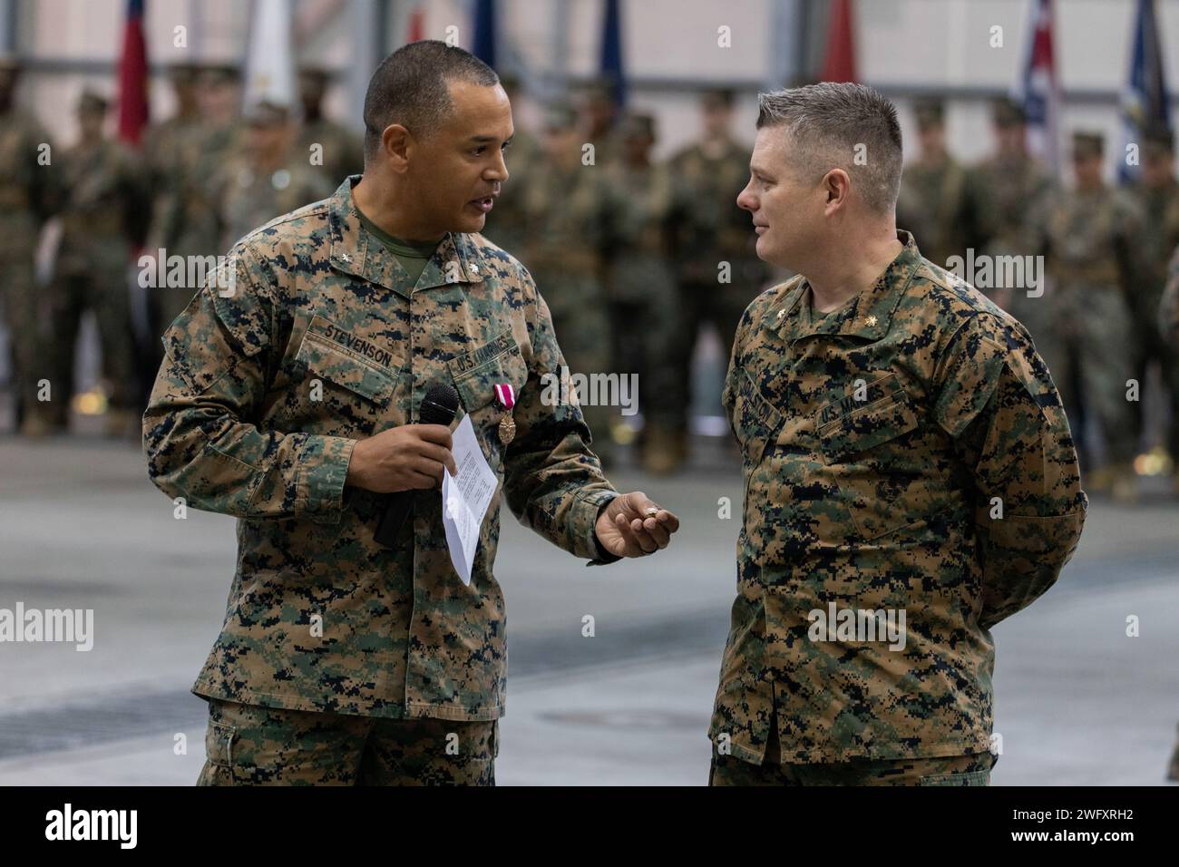 U.S. Marine Corps Lt. Col. Robert Stevenson III, left, presents a gift ...
