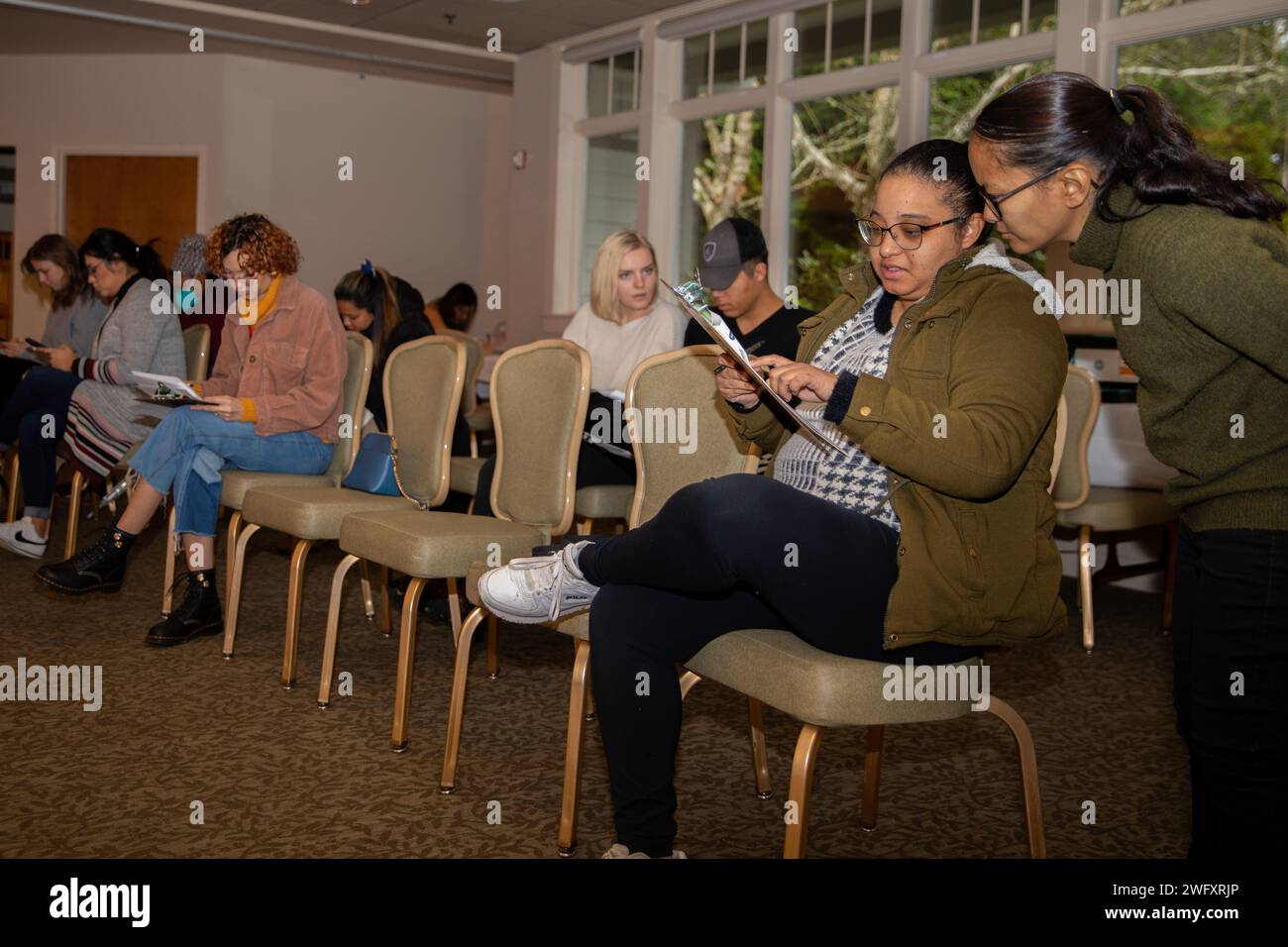 Applicants fill out processing information to apply for positions with ...