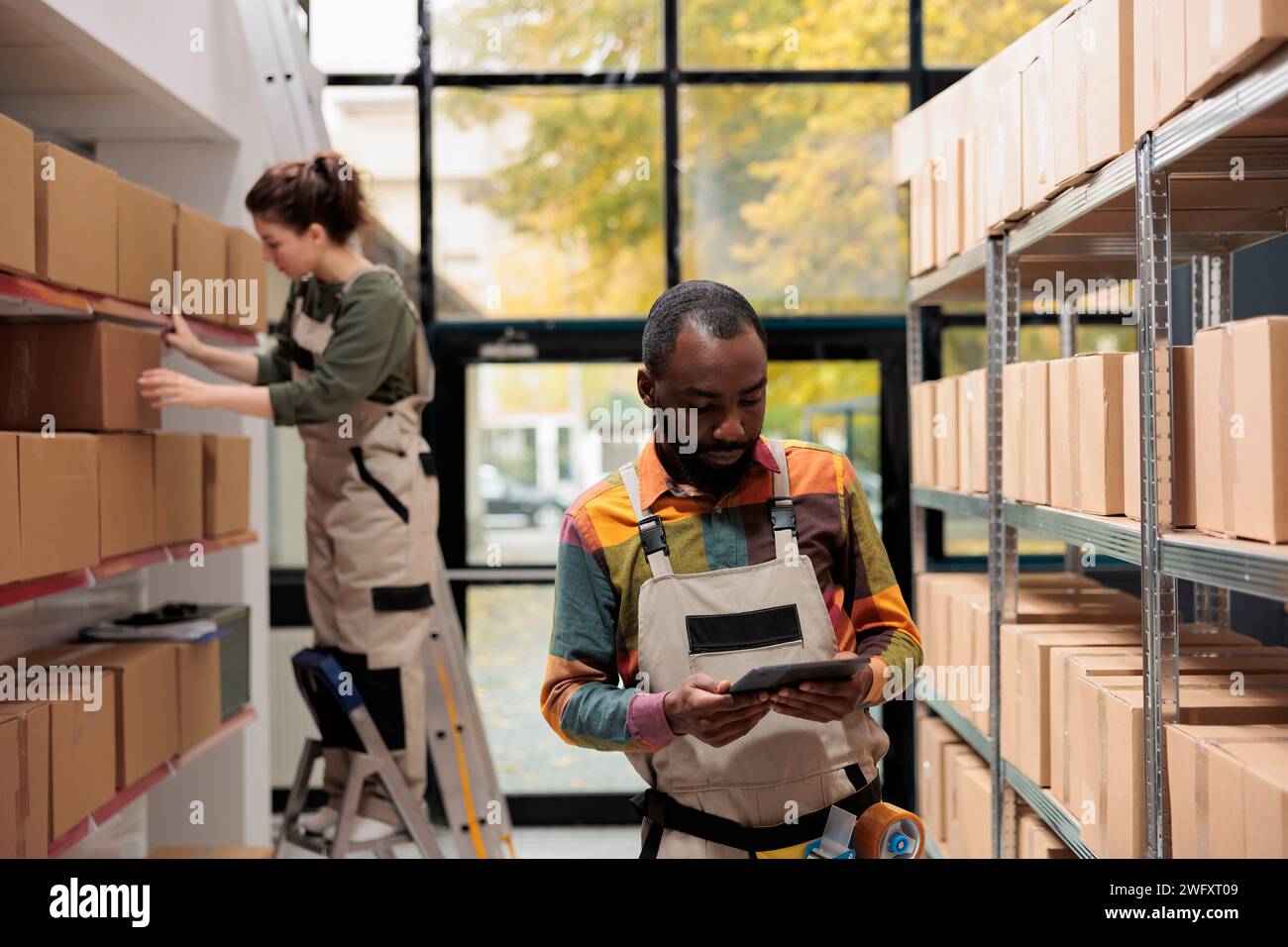 Warehouse employee analyzing merchandise checklist before start ...