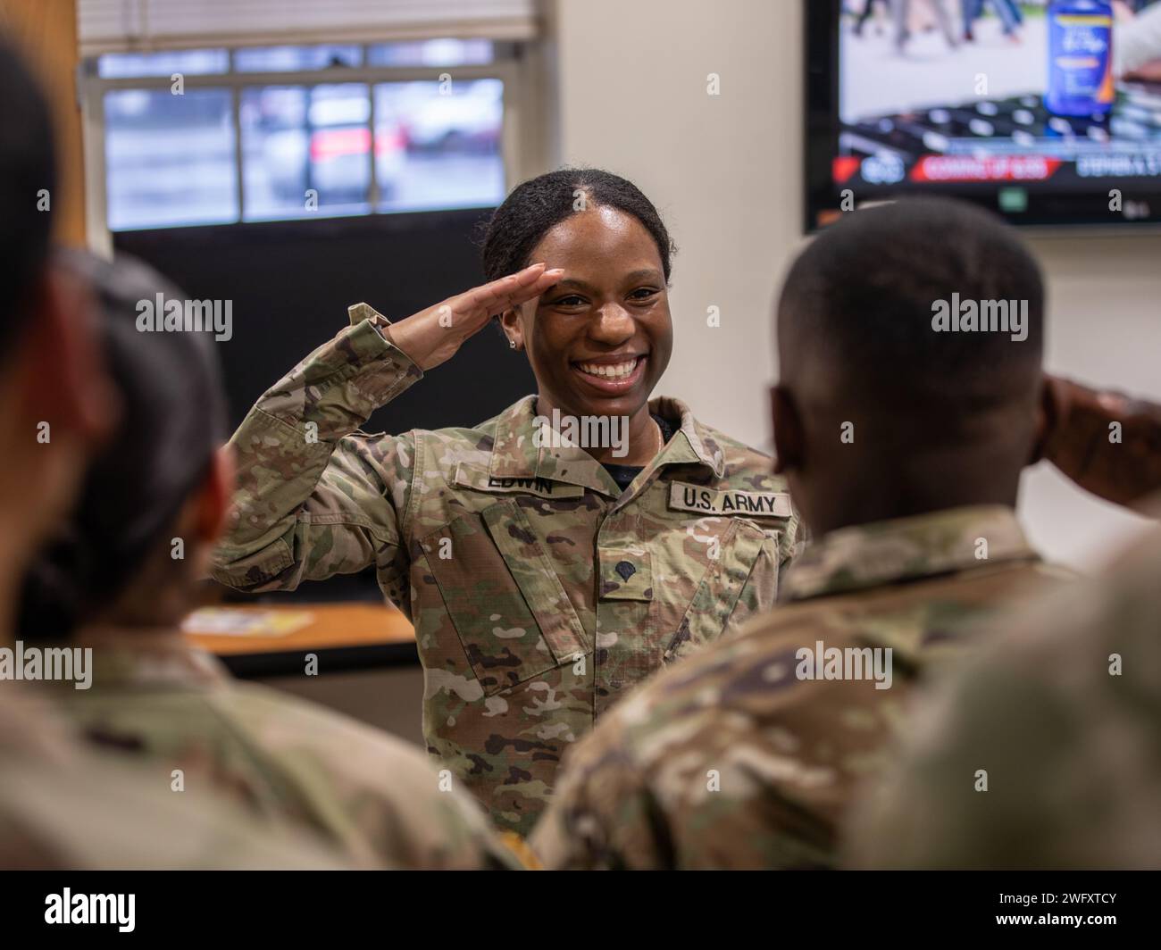 U.S. Army Spc. Monique Edwin, salutes a formation of soldiers in the ...