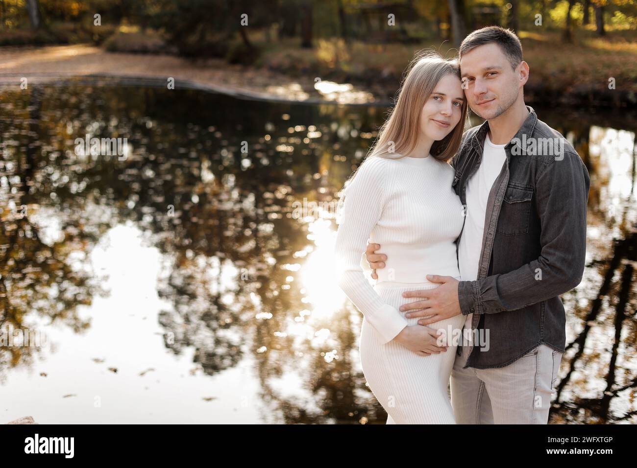 Family day. Stylish marriage pregnant couple waiting for baby. Man is ...