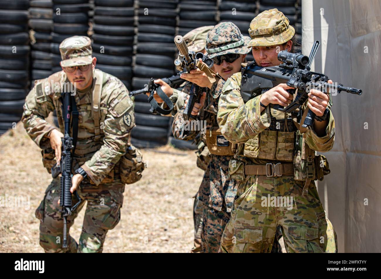 A U.S. Marine, Australian Soldier, and two U.S. Army Soldiers, assigned ...