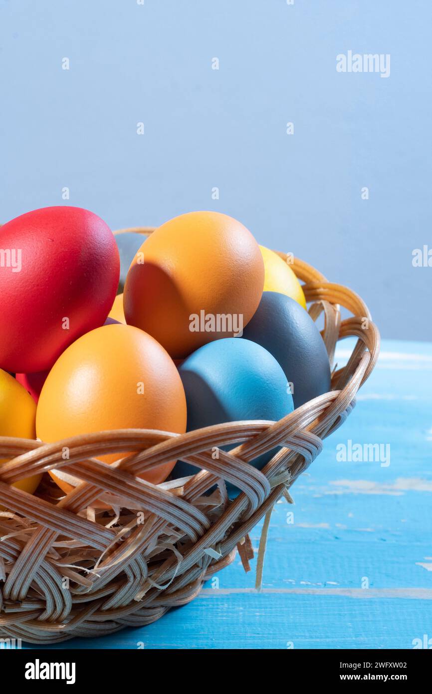 easter basket with straw and colored eggs to symbolize a religious ...