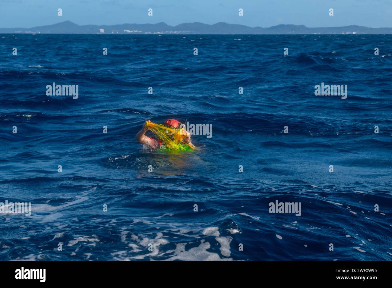 A U.S. Air Force Airman assigned to the 31st Rescue Squadron tears open ...