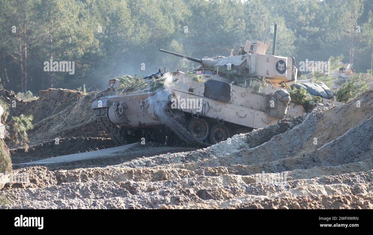 An M2 Bradley Infantry Fighting Vehicle barrels through the newfound ...