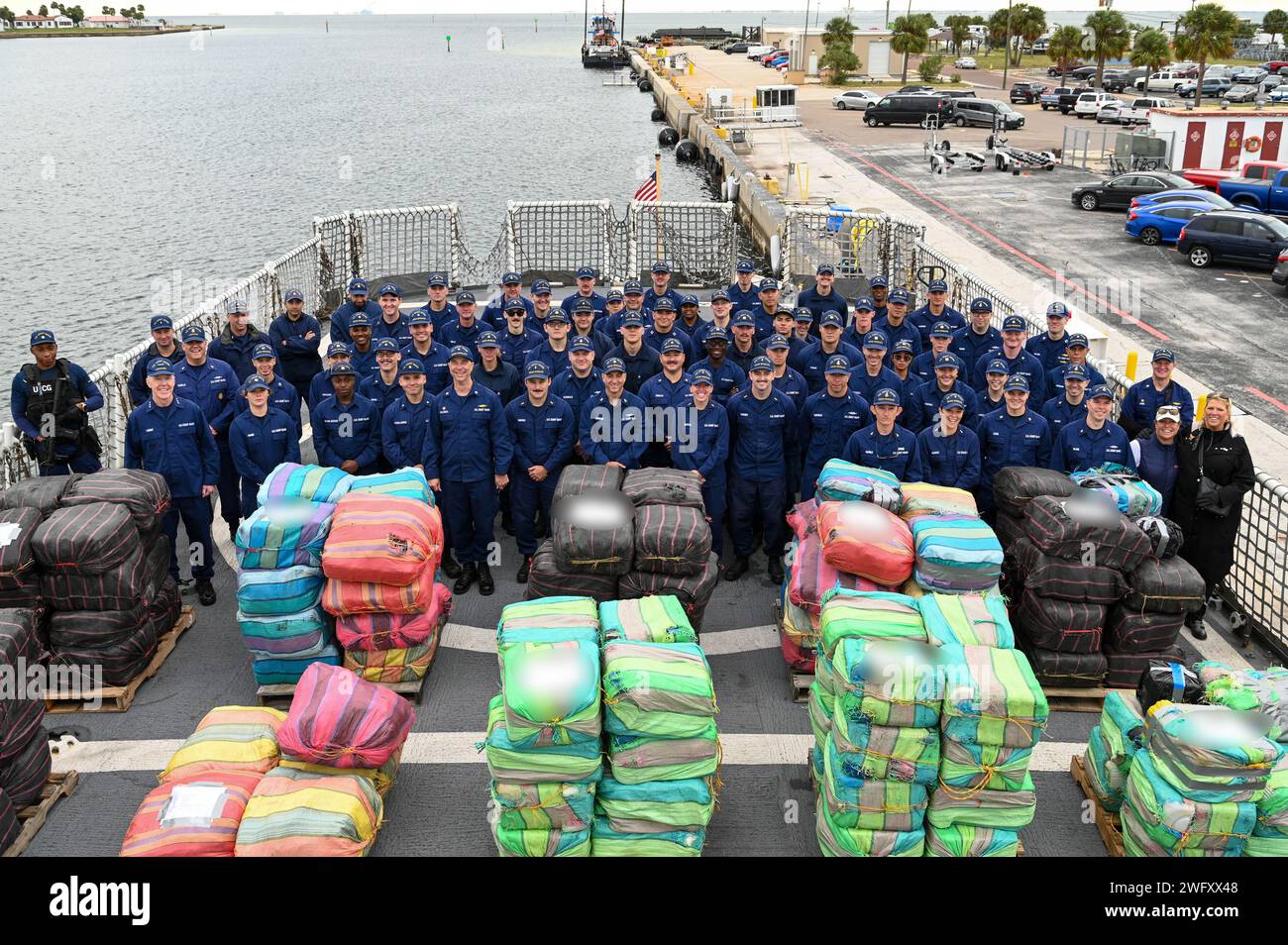 The crew of the Coast Guard Cutter Resolute pose in front of ...