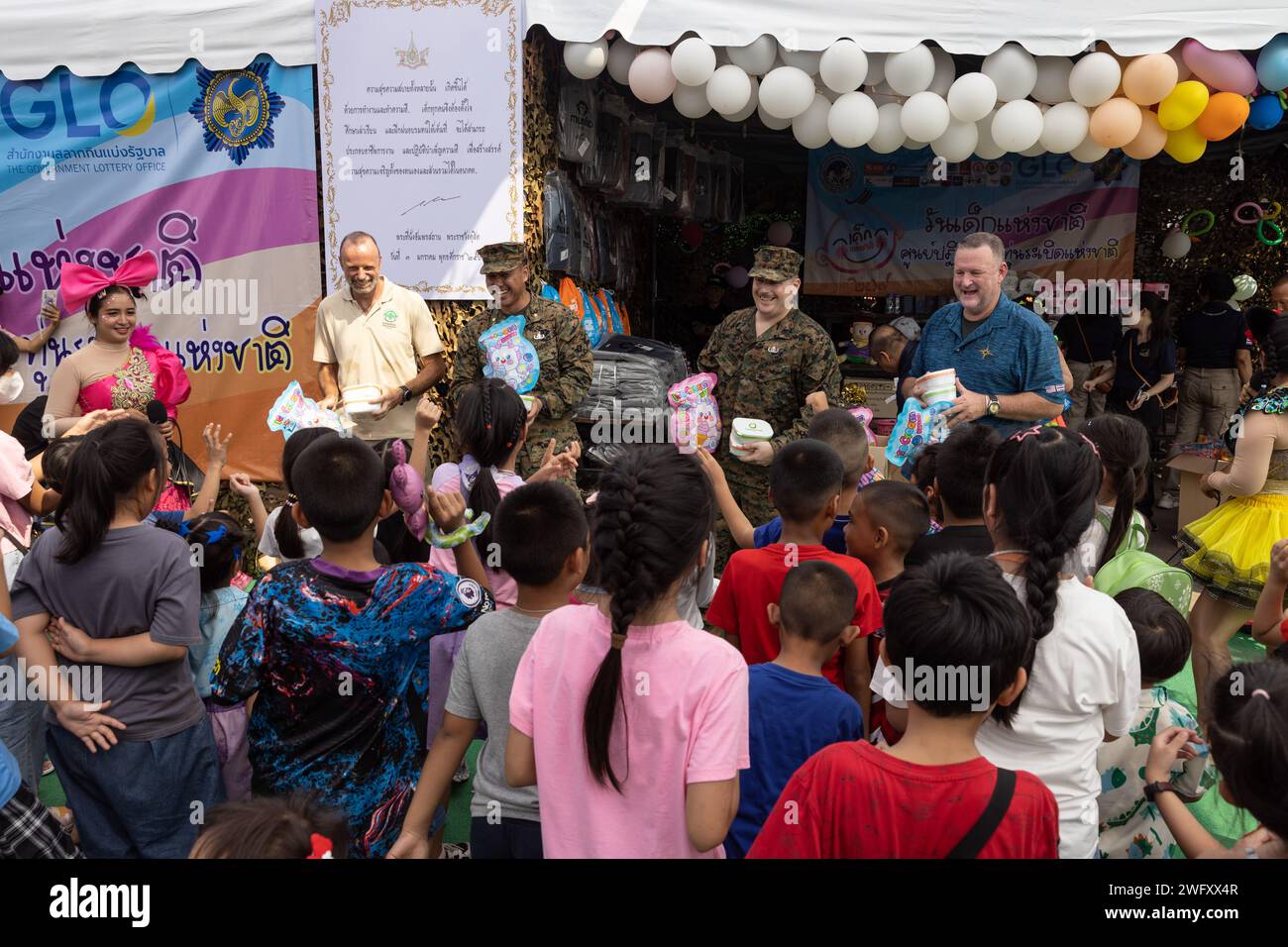 U.S. Marine Corps Maj. Isaac Tibayan, center left, the Humanitarian ...