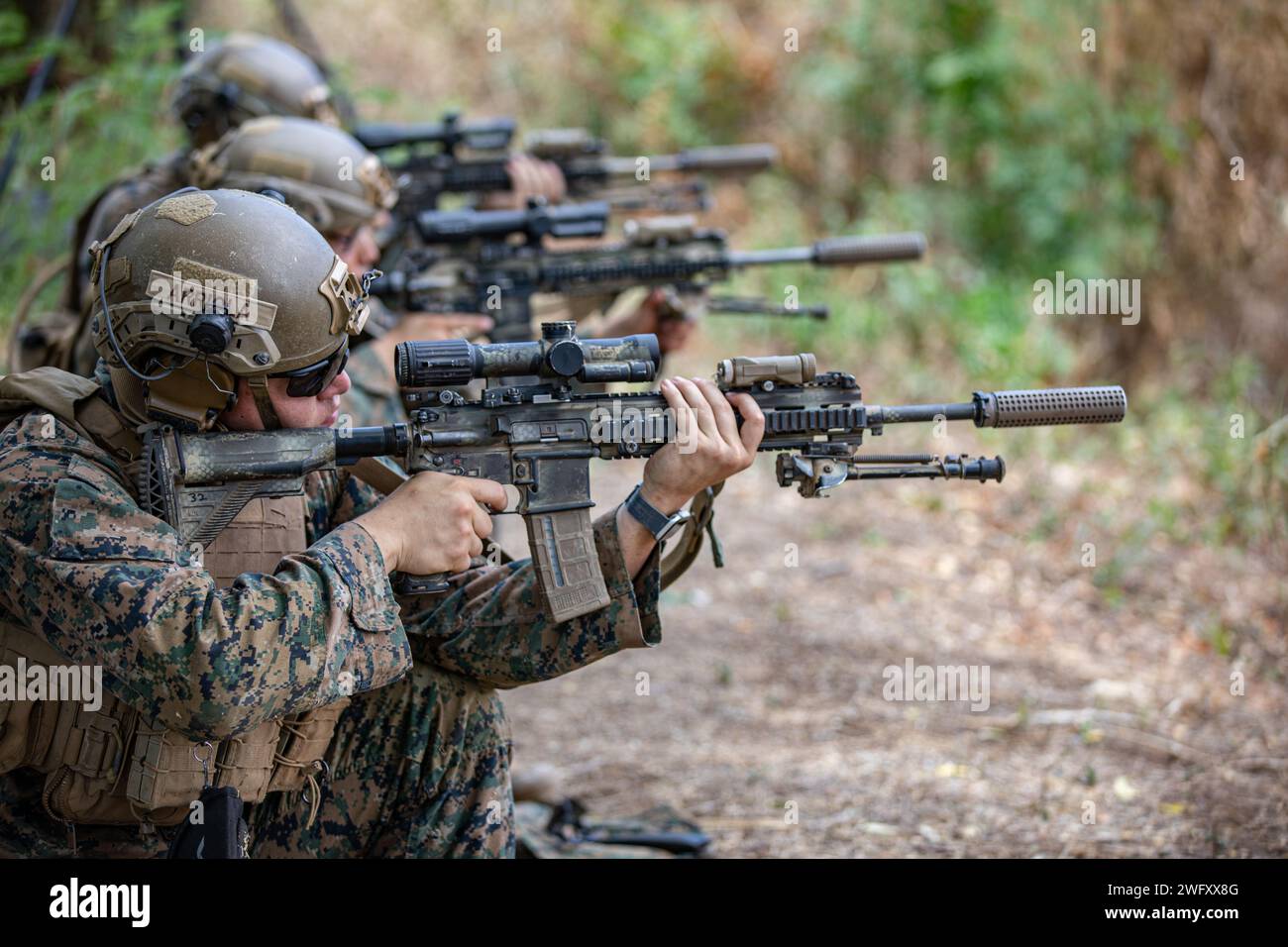 A group of U.S. Marines fires their M27 Infantry Automatic Rifle on an ...