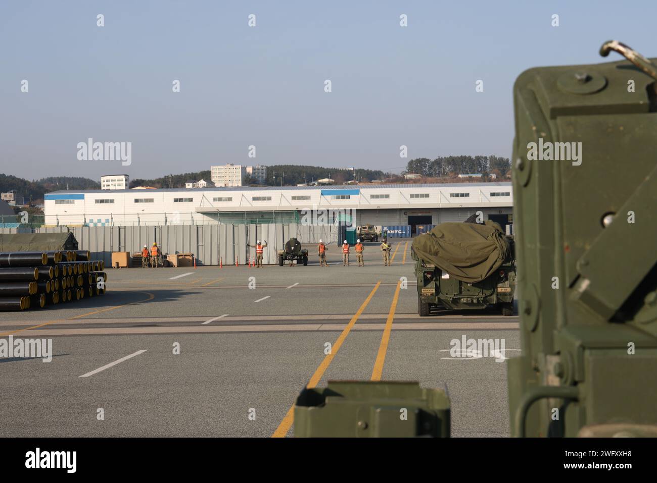 A U.S. Army Soldiers help guide a stryker vehicle to a staging area ...