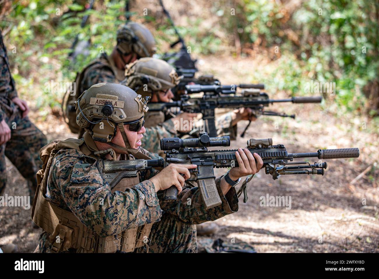 A group of U.S. Marines fires their M27 Infantry Automatic Rifle on an ...