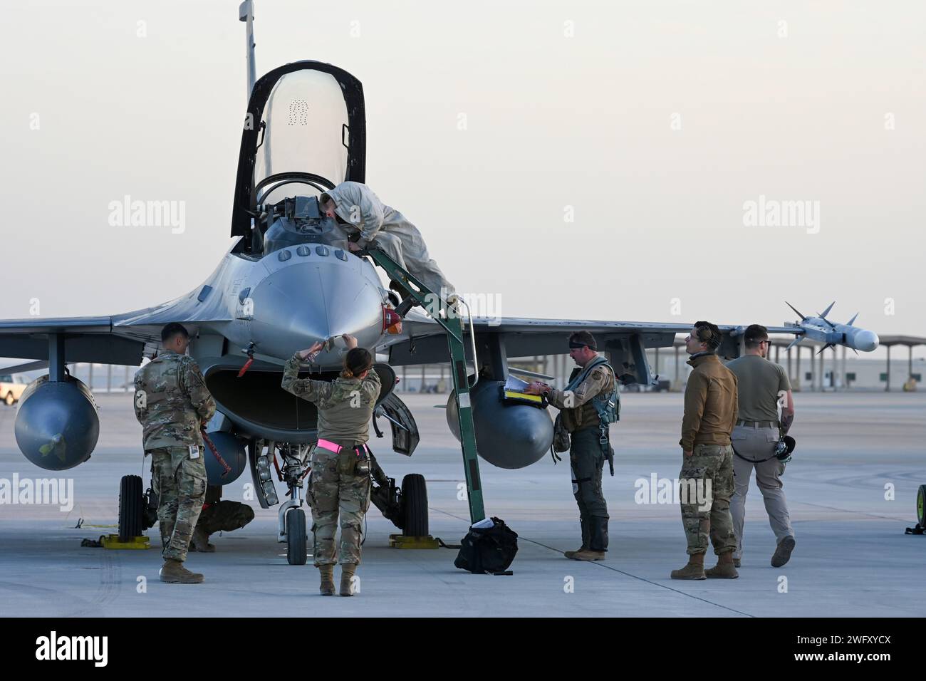 U.S. Air Force personnel assist in conducting post-flight checks of a U ...