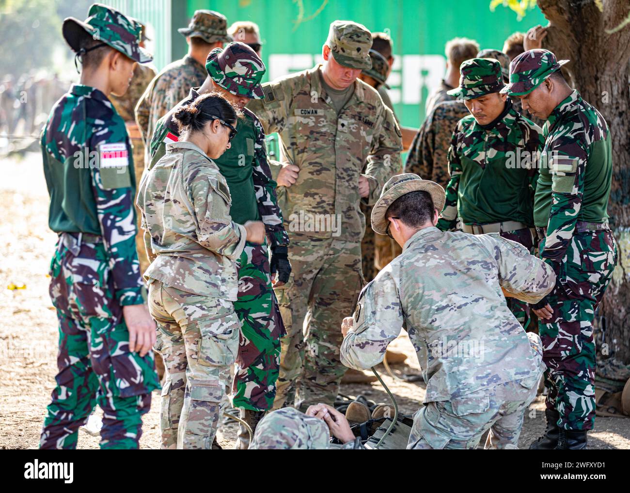 Two U.S. Army Soldier, assigned to the 25th Infantry Division, assist ...