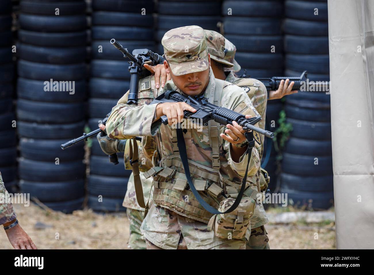 U.S. Army Soldiers stack up and prepare to breach on a mock door during ...