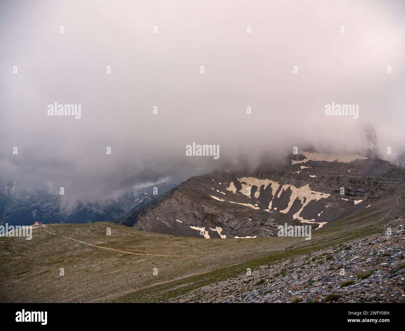 Plateau of muses with refuge and camps in view during cloudy summer ...