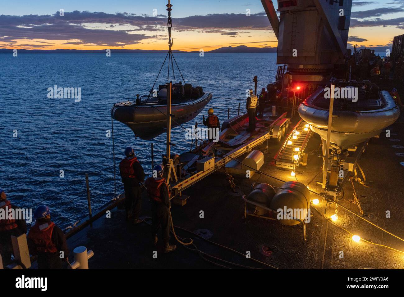 A U.S. Marine Corps 11m rigid hull, inflatable boat is lowered from ...