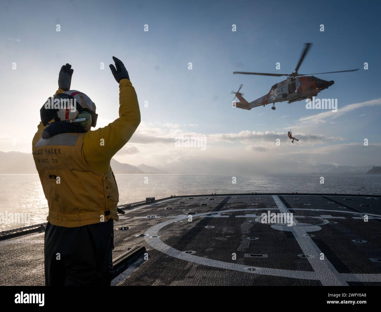 A crew member from Coast Guard Cutter Alex Haley conducting helicopter ...