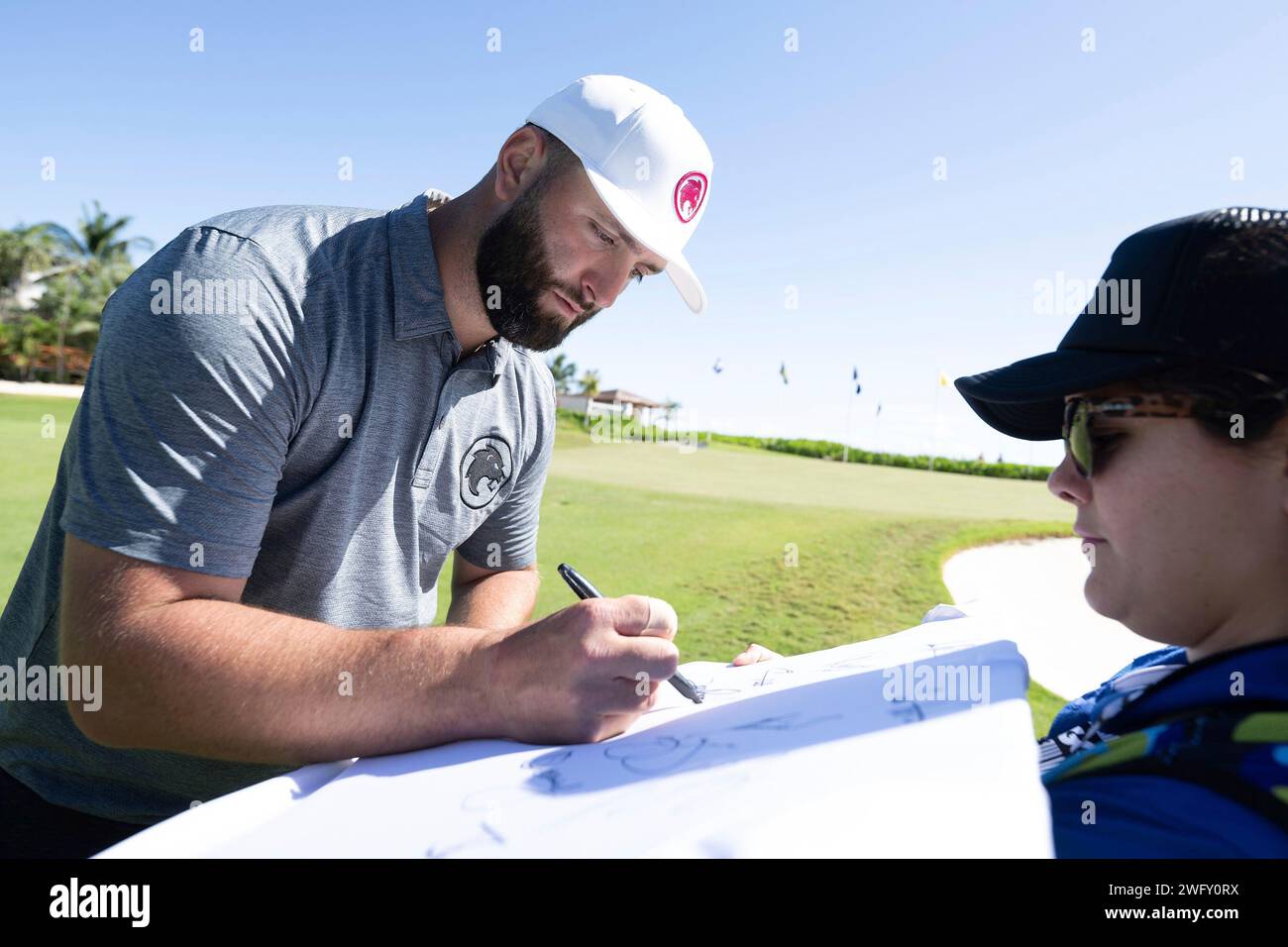 Jon Rahm of Legion XIII GC signs his autograph for a fan during the pro ...