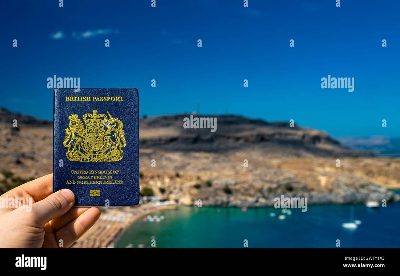 Man holding UK passport against the backdrop of a tropical country ...