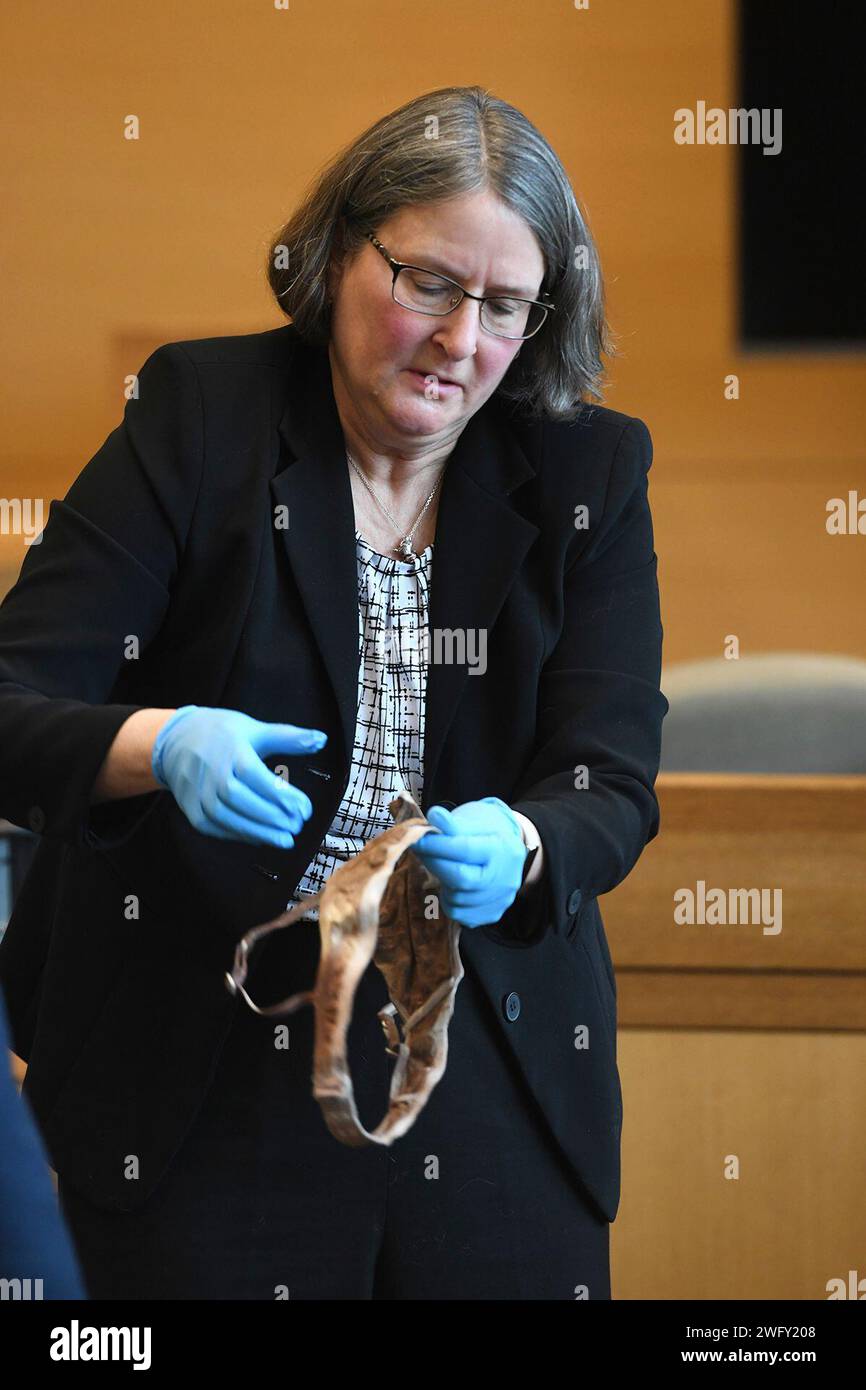 Christine Roy, state forensic science examiner, holds a bra presented ...