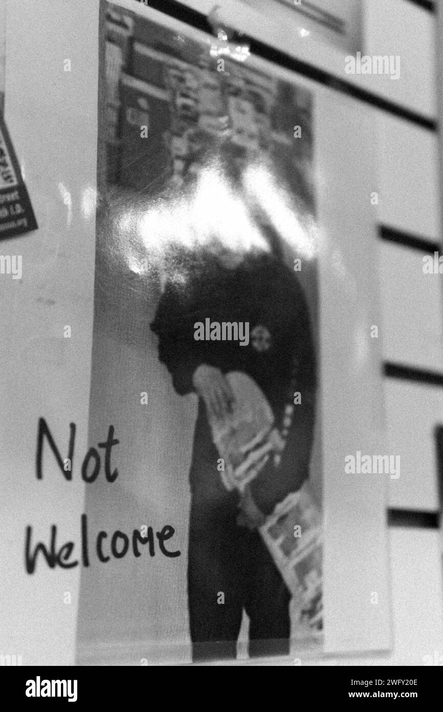 Ironic photo using the light as a reflection of a not welcome sign ...