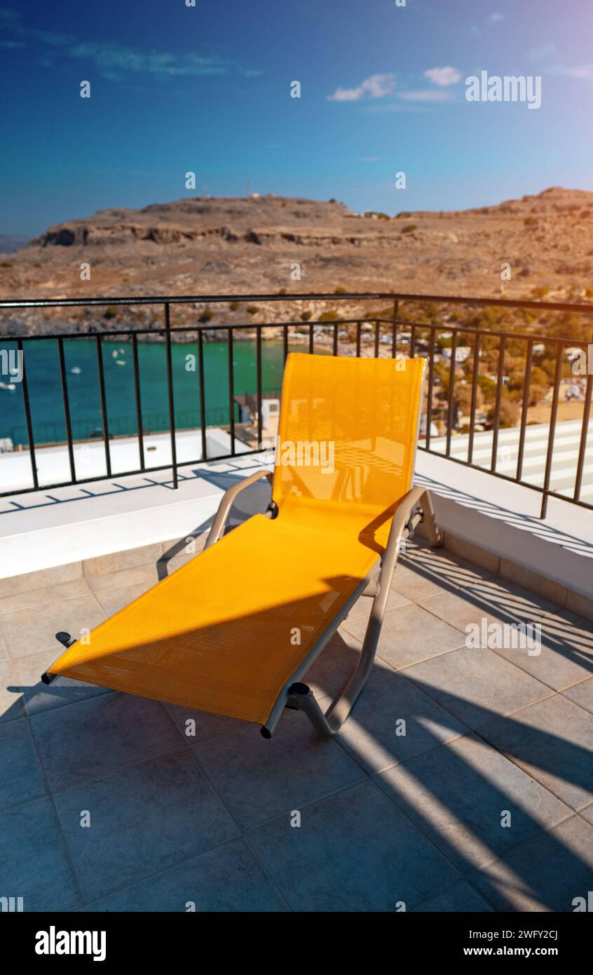 Yellow sun lounger on the balcony overlooking the beach Stock Photo - Alamy