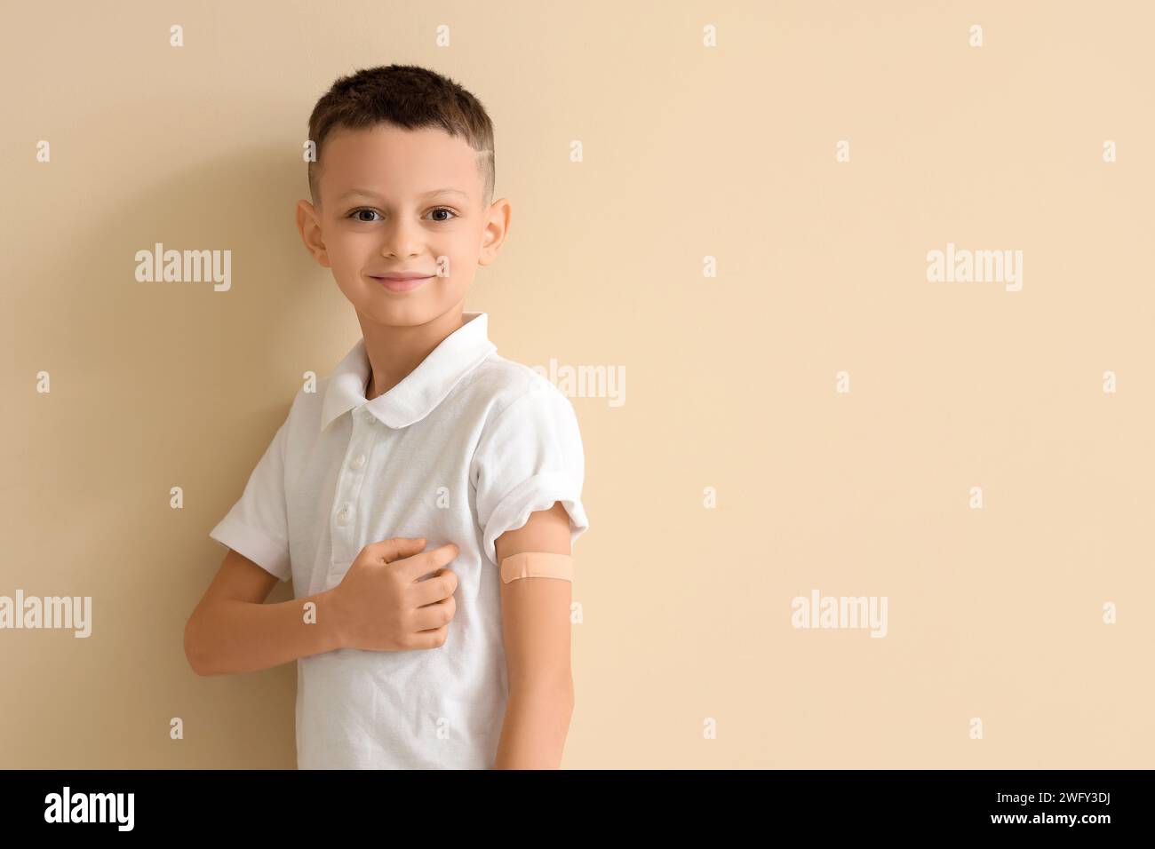 Little boy with plaster after vaccination on beige background Stock ...