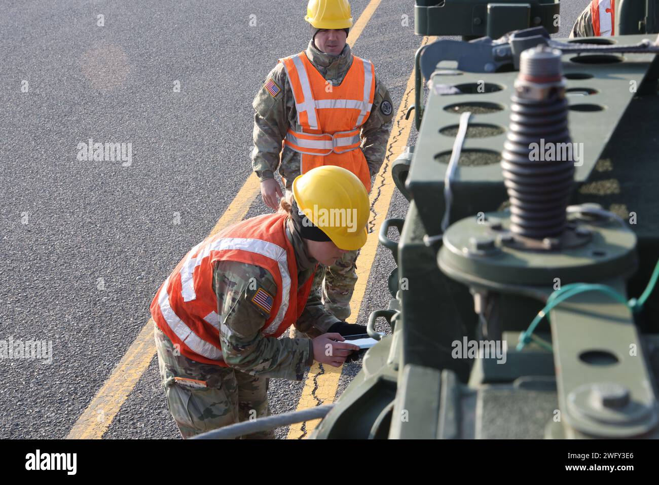U.S. Army Soldiers help guide a stryker vehicle to a staging area after ...