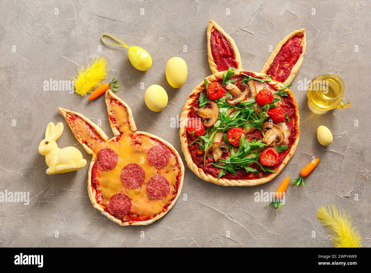 Composition with tasty pizzas and eggs on grey background. Easter ...
