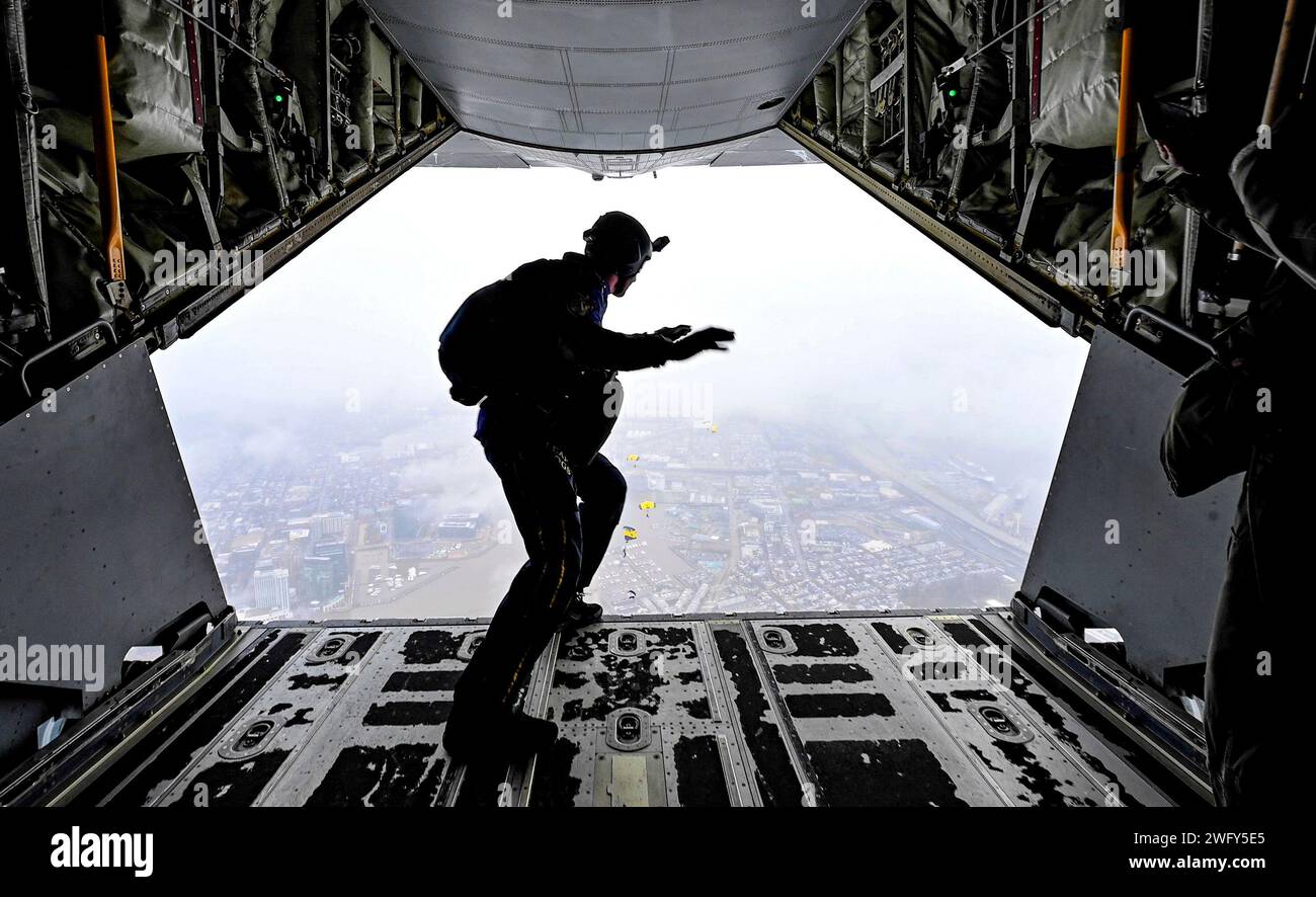 A U.S. Navy Parachute Team member prepares to jump out of a C-130 ...