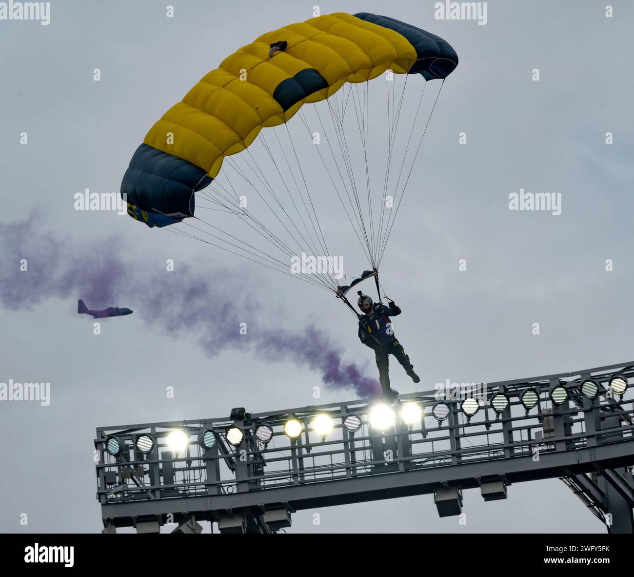 A U.S. Navy Parachute Team member is skydiving into the Baltimore ...