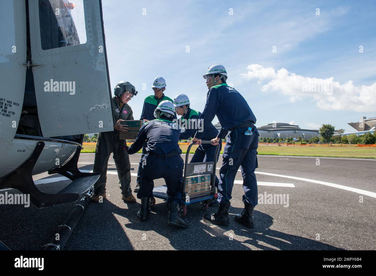 Members of the Tokyo Metropolitan Government receive a box of simulated ...