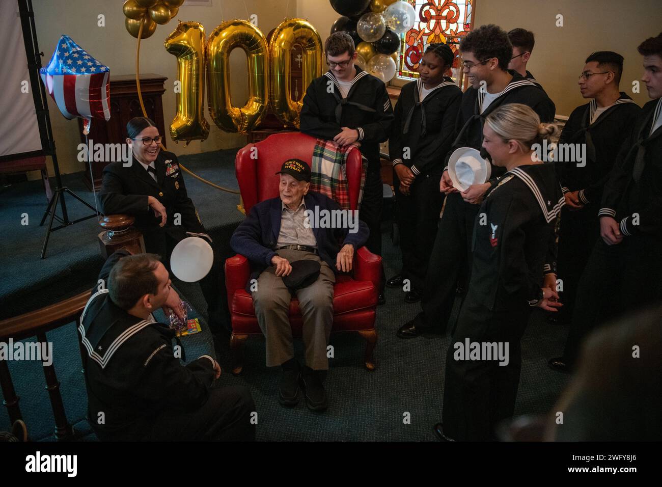 World War II veteran Albert Wend talks with Sailors during a ...