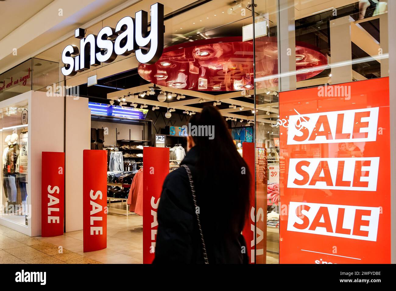Krakow, Poland. 31st Jan, 2024. A shopper walks in front of Sinsay shop ...