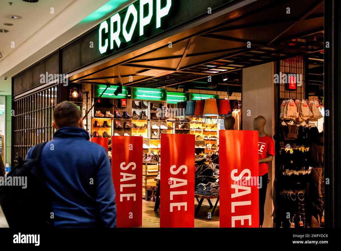 Krakow, Poland. 31st Jan, 2024. A shopper walks in front of Cropp shop ...