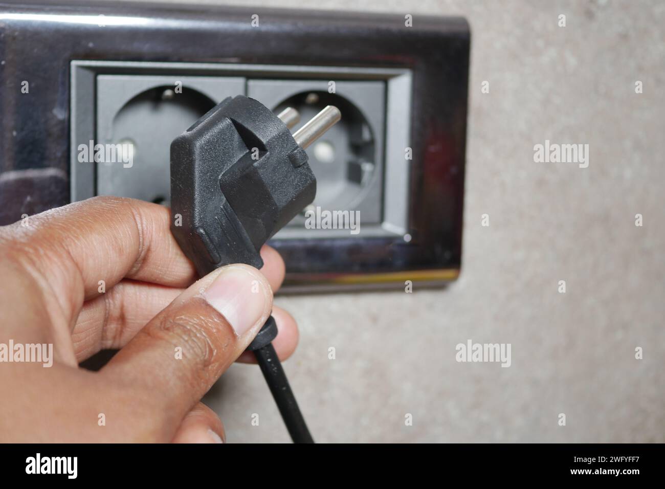 white color power cord cable plugged into wall Stock Photo - Alamy