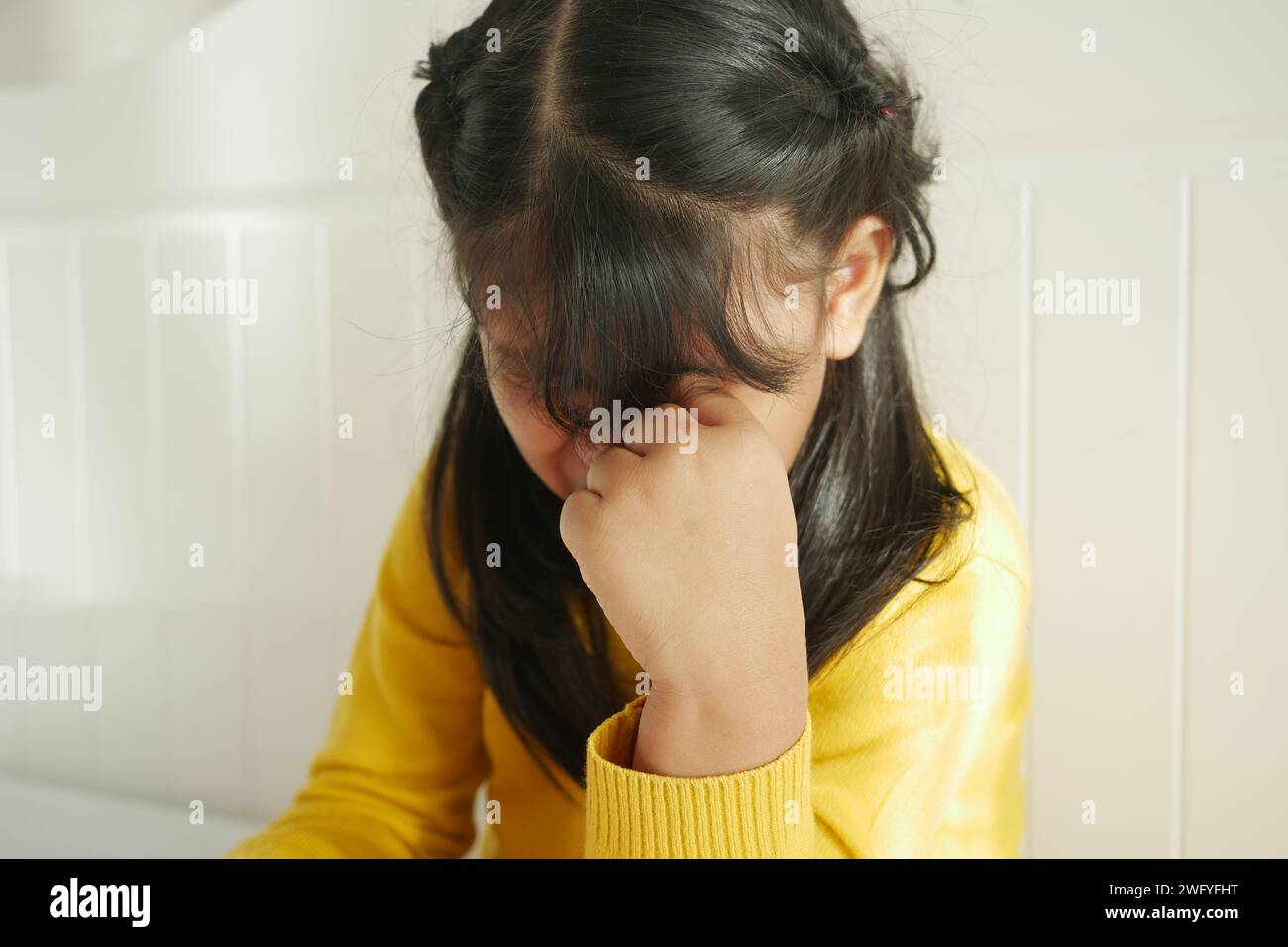 a upset child girl cover her face with hand Stock Photo - Alamy