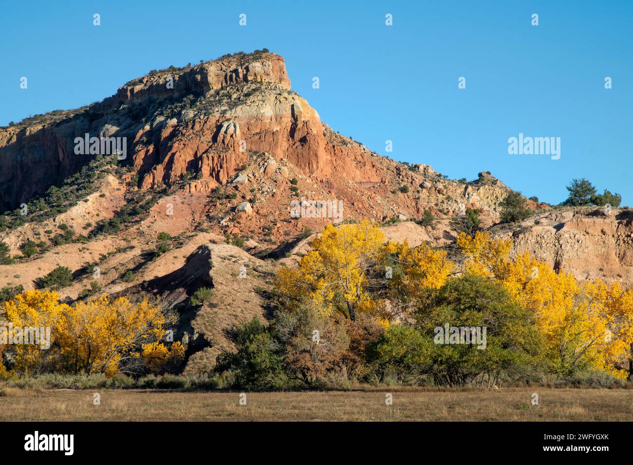 Fall foliage surrounds a sandstone rock formation along U.S. Route 84 ...