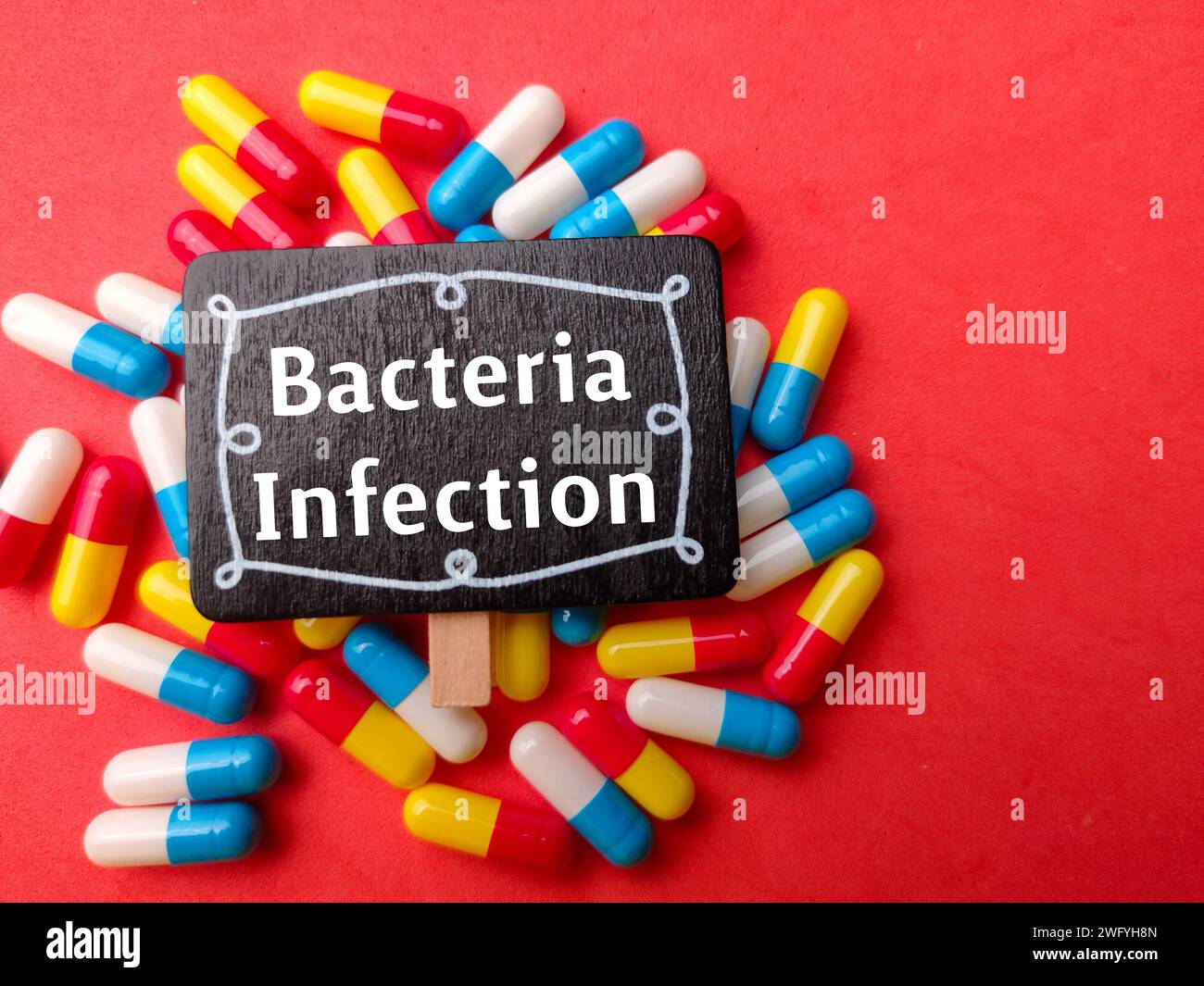 Top view wooden board and pill capsule with text Bacteria Infection on ...