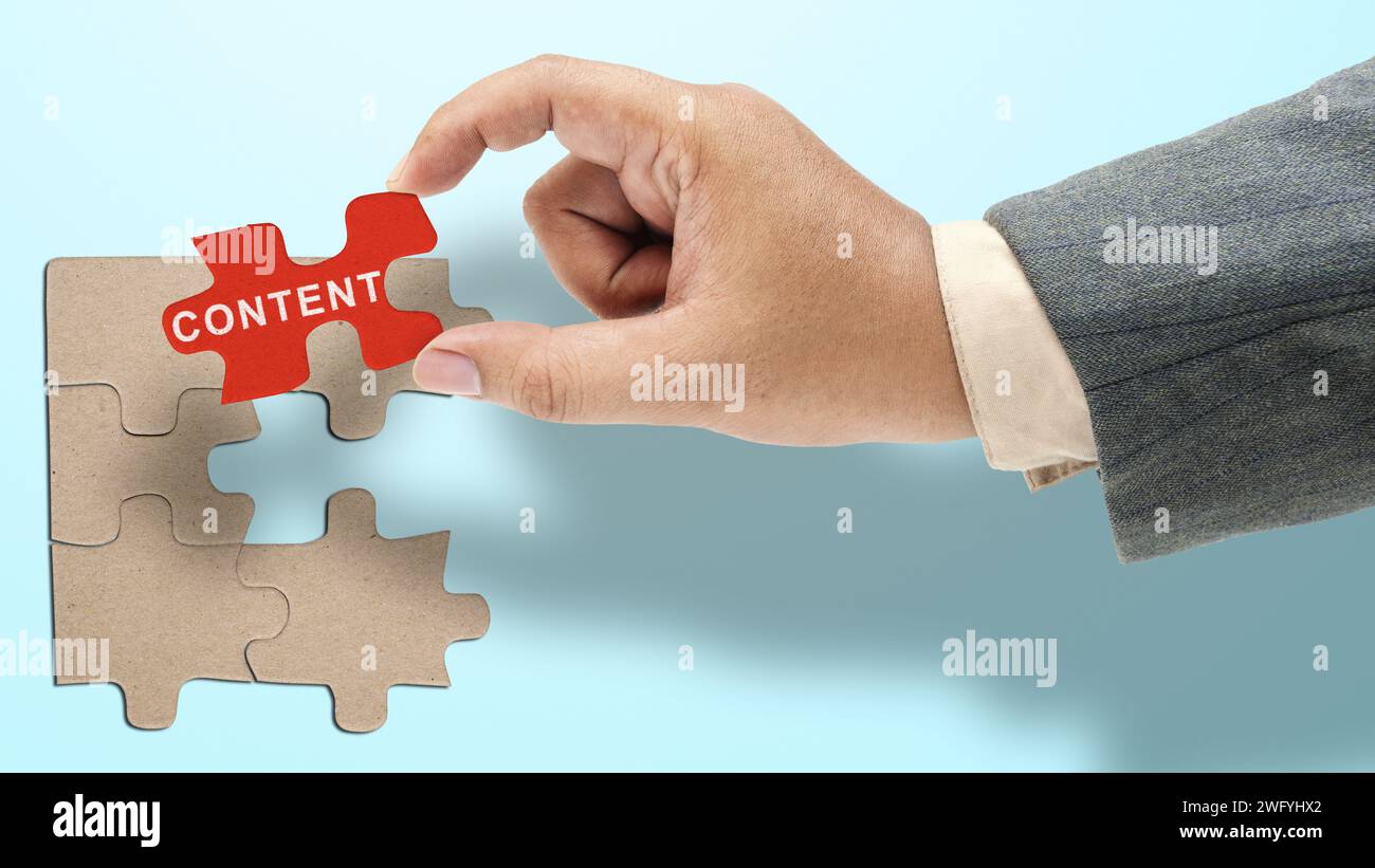 Business hand showing content text on a piece of jigsaw puzzle. Content ...